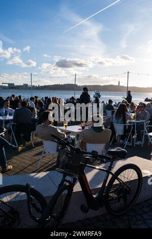 People enjoying Ribeira das Naus, the riverfront promenade and urban ...