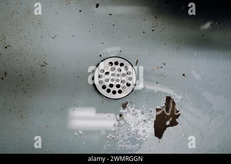 Overflowing drain in the laundry room - a sign of plumbing trouble that ...