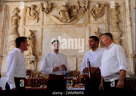 Croatian men wearing traditional dress singing at Trogir Loggia ...