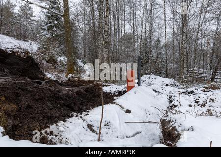 Trench with ventilation piping for home sewage under construction in ...