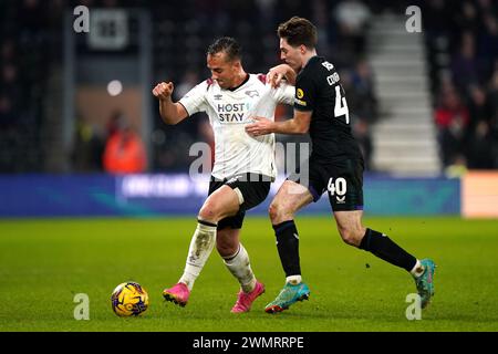 Derby County's Kane Wilson (left) and Watford's Rocco Vata battle for ...