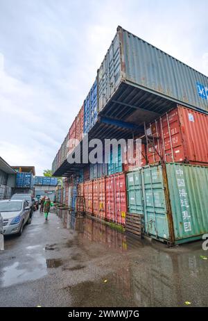 A typical view of the many old, stacked, reused shipping containers ...