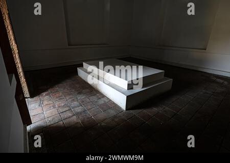 A white tombstone inside an ancient crypt in the old city of Samarkand ...