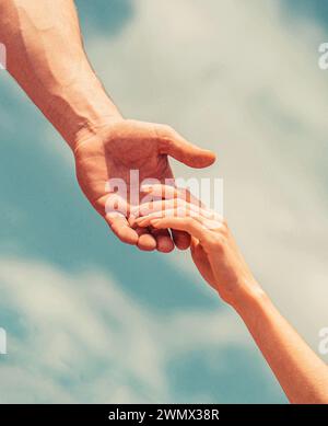Couple of helping and praying hand on sky background. Giving a helping ...