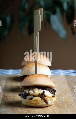 Mini beef burgers are small-sized sandwiches made with seasoned beef ...