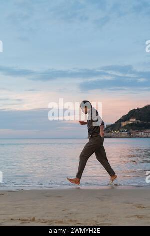Gentle ocean waves lapping against a sandy beach, creating a smooth ...