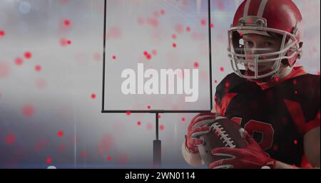 Image of red spots over male american football player with ball Stock ...
