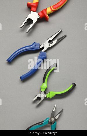 Bent nose pliers on grey background, top view. Space for text Stock ...