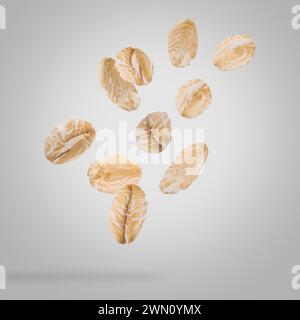 Rolled oat flakes falling on beige background Stock Photo - Alamy