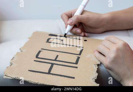 Sheet of paper with Help sign in male hand on dark background Stock ...