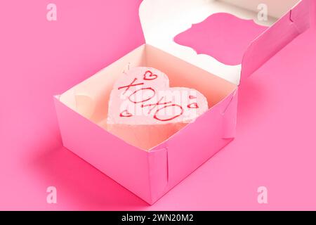 Box with heart-shaped bento cake and gift on white background ...
