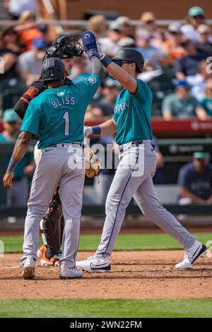 Seattle Mariners' Ryan Bliss and Dominic Canzone (8) are reflected in ...