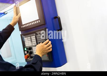 Worker hand controling cnc machine at workshop Stock Photo - Alamy