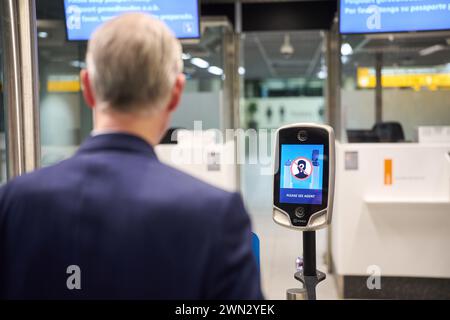 Passengers go through passport control booth at Chopin airport in ...