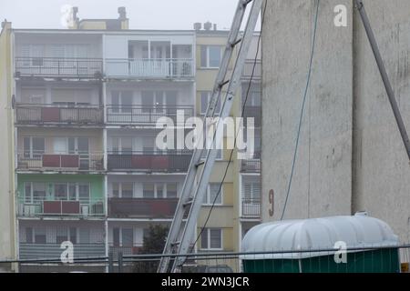 High ladder against the wall of a block of flats Stock Photo - Alamy