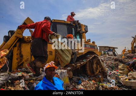 Nairobi, KENYA. 28th Feb, 2024. A waste collector walks past waste bags ...