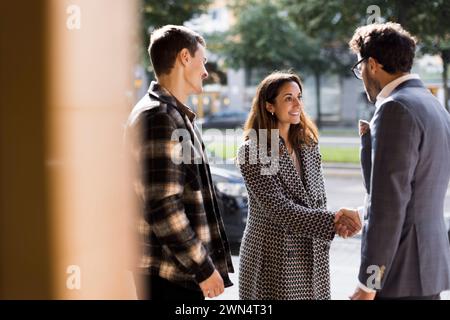 Male real estate agent with handshake smiling in white real estate room ...