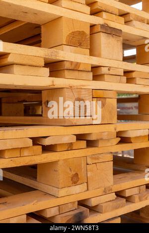 Piles of stacked natural wooden shipping pallets. Outside a big stack ...