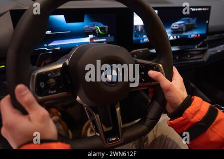 Interior, cockpit of BMW i5 eDrive40 car, digital panel, instruments on steering wheel, EV ...