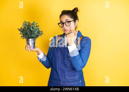 Caucasian woman pointing to eye watching you gesture, suspicious ...