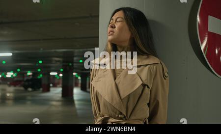 Frightened Asian ethnic chinese korean woman hiding from danger pursuit ...
