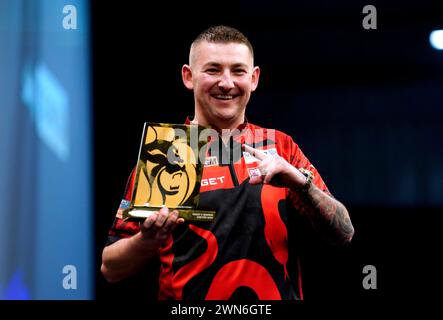 Nathan Aspinall celebrates with the trophy after winning the final ...
