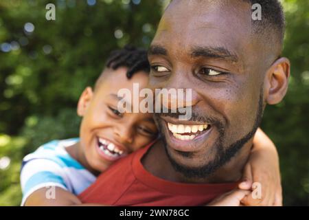 A father and son share a joyful embrace, celebrating their bond on ...