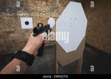 Tactical shooting from a pistol g19 with a red dot at targets in a ...