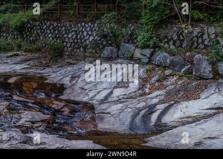 Shallow river cascading over large boulder in wilderness park in South ...