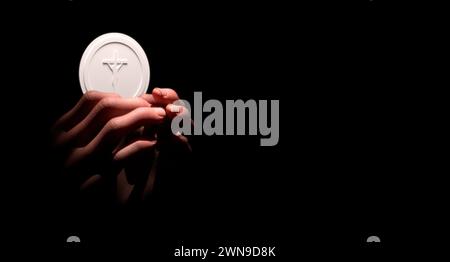 A priest who holds the consecrated host, who is Our Lord Jesus Christ ...