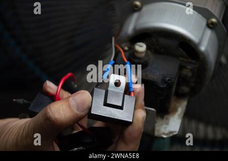 Capacitors in the fan motor circuit, fan repair technician Stock Photo ...