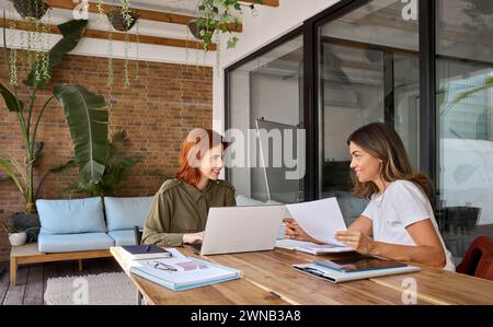 Two happy colleagues in green clothing in office Stock Photo - Alamy