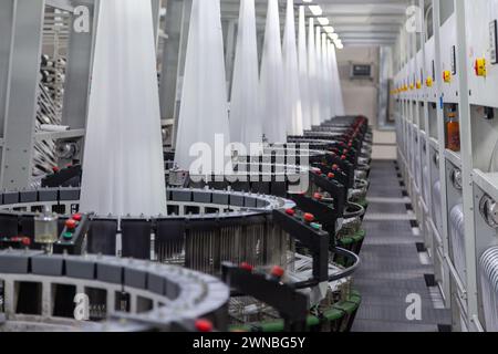 Interior of a factory shop. A series of equipment for weaving ...