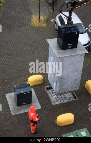 Underground residual waste containers being emptied by the municipal ...