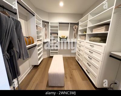 Spacious Walk-In Closet with Custom Shelving and Seating Stock Photo ...