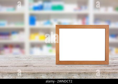 wood photo frame on the pharmacy counter over blur shelves of drug in ...