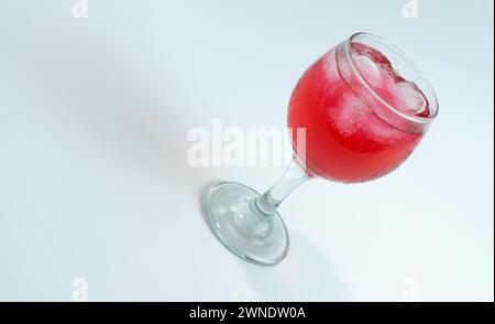 Raspberry or frambozen flavored red syrup in glass cup isolated on ...