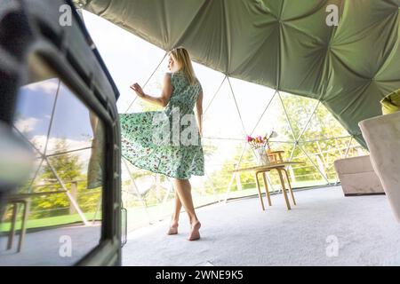 a woman enjoys solitude inside of a transparent bubble hotel Stock ...