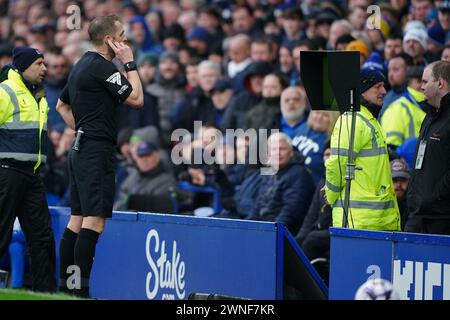 Referee Craig Pawson reviewing VAR before awarding a penalty to Everton ...