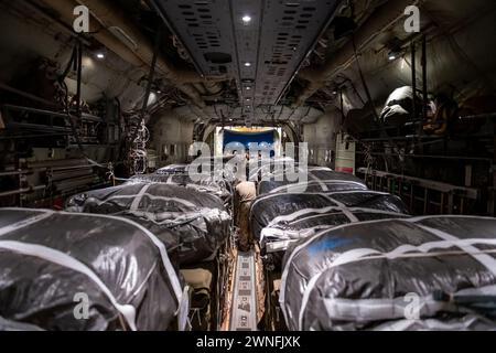 Humanitarian aid pallets rigged with parachutes for airdrop aboard a C ...