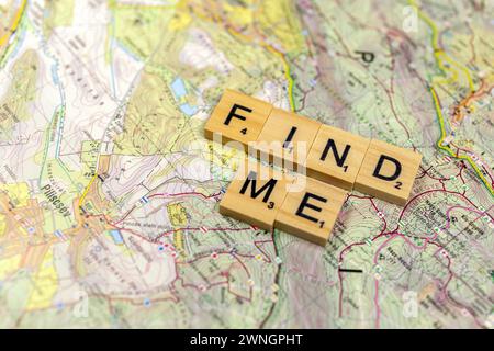 "Find me" wooden letters on an old paper map Stock Photo - Alamy