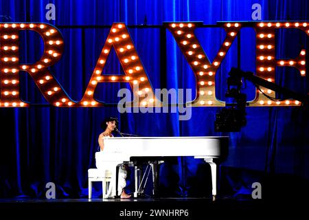 Raye performing on stage during the Brit Awards 2024 at the O2 Arena ...