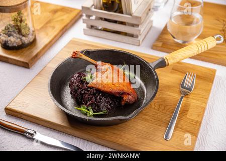 Portion of roast duck leg served with red cabbage Stock Photo - Alamy