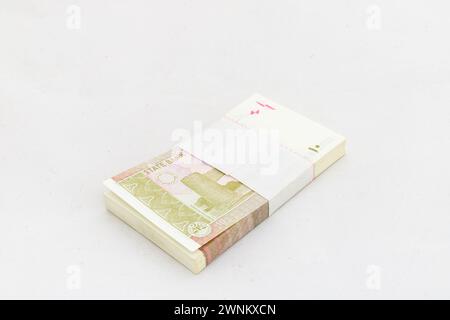 Pakistan ten rupees denomination note bundle on white isolated ...
