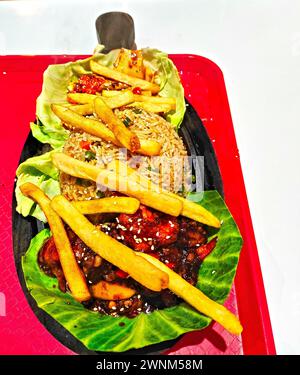 A plate of Chicken Sizzler with Fries Stock Photo - Alamy