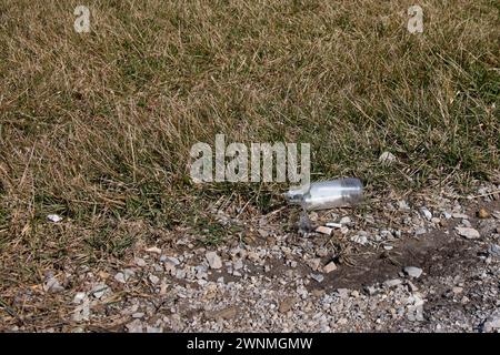 Litter in the grass along a roadside Stock Photo - Alamy