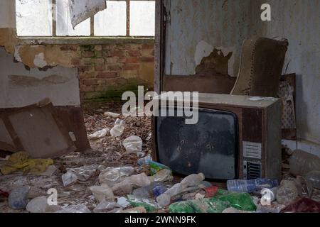 discarded dumped television amongst empty plastic bottles inside ...