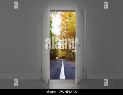 Open door in brick wall inviting to visit mountains Stock Photo - Alamy