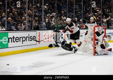 New Jersey Devils' Kevin Bahl, right, passes around New York Rangers ...