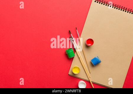 Album pages and paints, pencils, brush on a colored background. Top ...